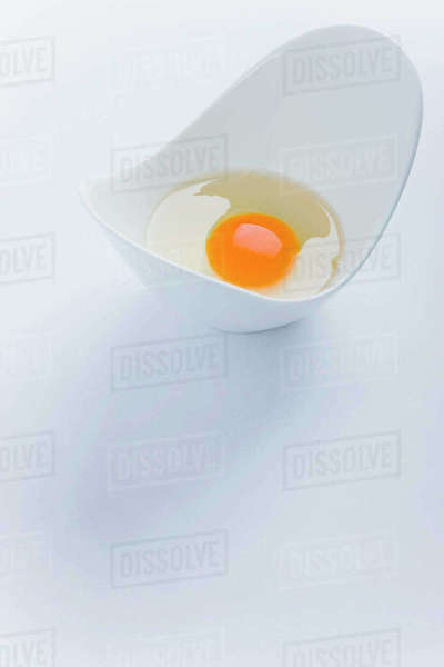 Uncooked Egg in White Container - Stock Photo - Dissolve