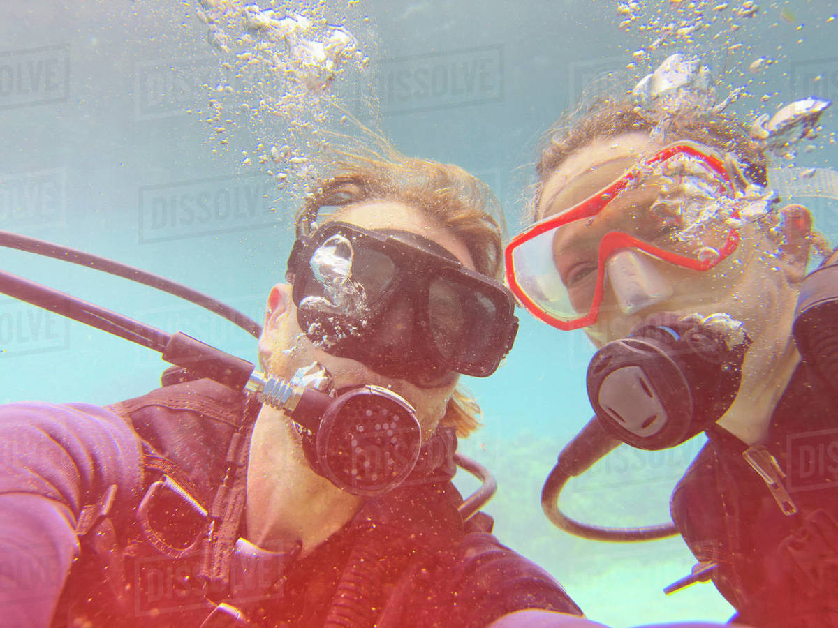 Portrait happy couple scuba diving underwater in sea, Kingstown, Saint ...