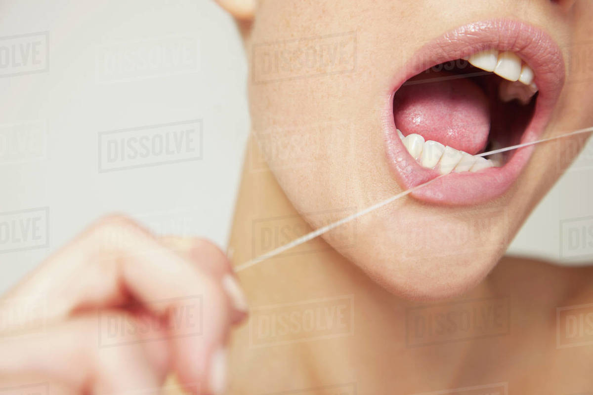 Woman Flossing Teeth - Close-up view - Royalty-free Stock Photo | Dissolve