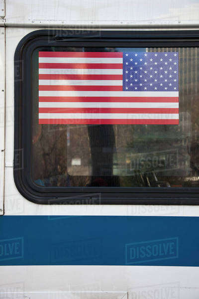 American flag on a bus window - Stock Photo - Dissolve