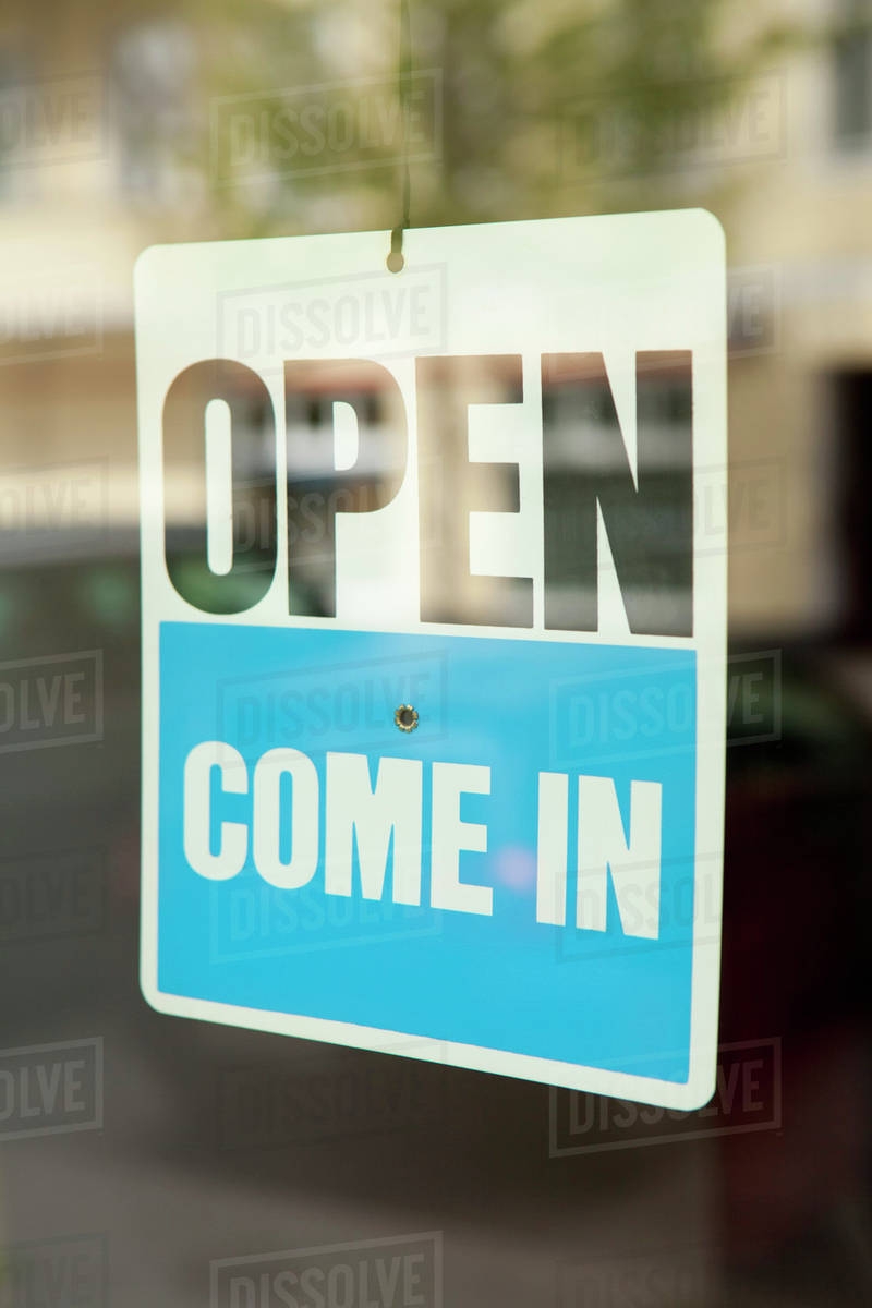 An OPEN COME IN sign hanging in the window of a shop door - Stock Photo ...