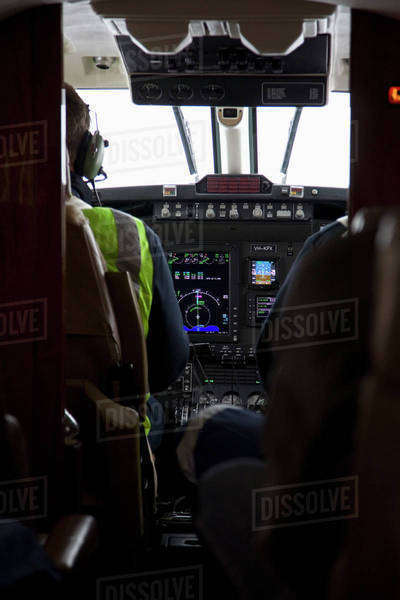 Pilot and co-pilot in the cockpit of an airplane, rear view - Stock ...