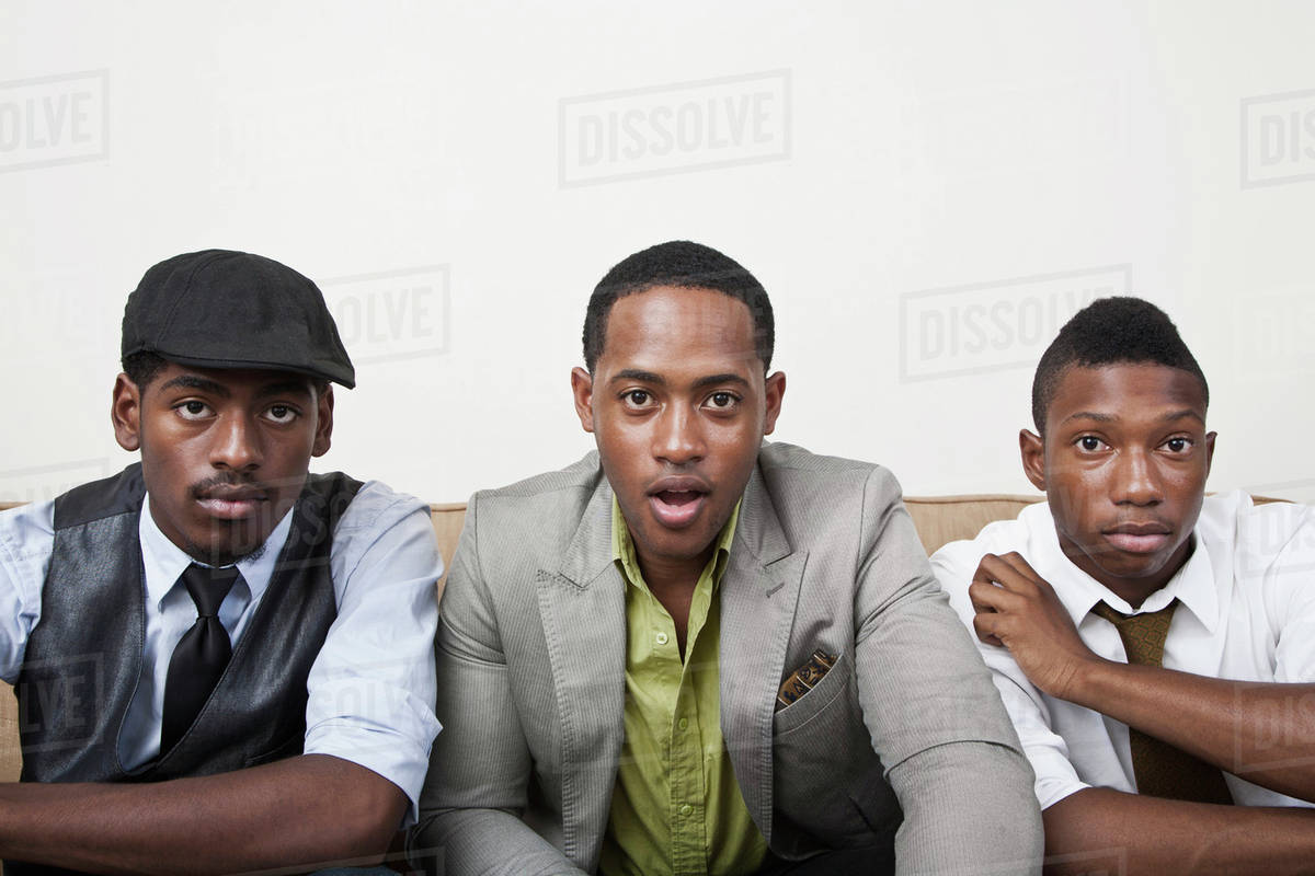 Three men sitting side by side looking surprised - Royalty-free Stock ...